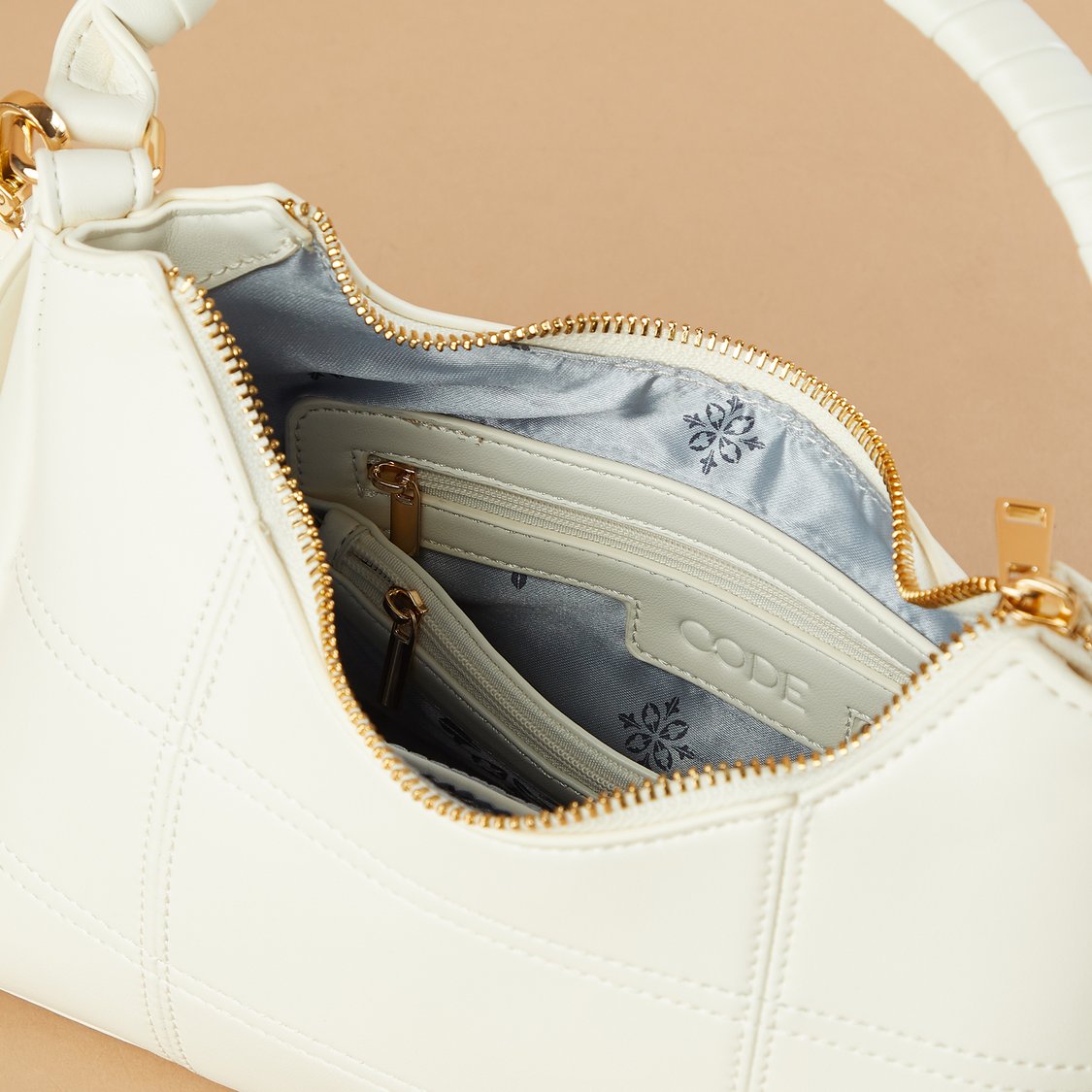 Buy CODE Textured Sling Bag from CODE at just INR 2499.0